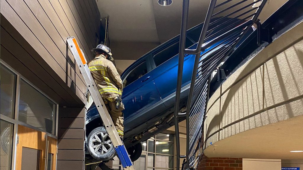 Driver Stuck In SUV After Driving Off Parking Deck